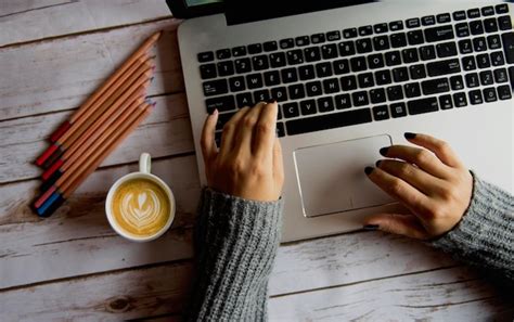 Premium Photo Cropped Hands Using Laptop At Table