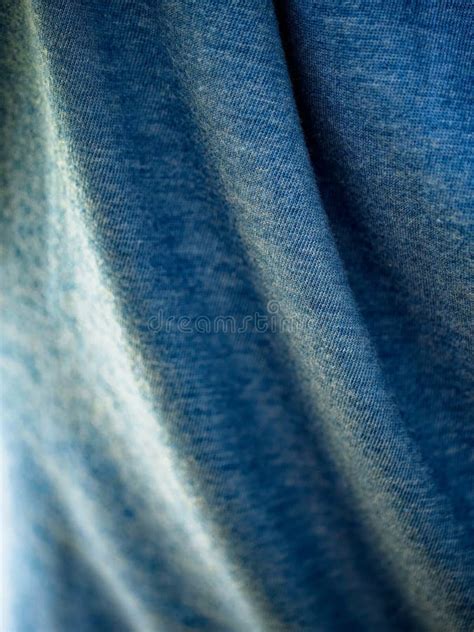 The Image Shows A Close Up Of Blue Fabric With Visible Texture And Folds The Material Appears