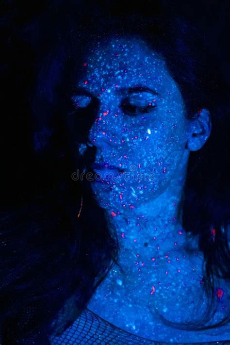 Portrait Of A Beautiful Woman With Blue Sequins On Her Face Girl With Artistic Make Up In Light