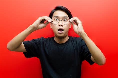 Premium Photo Shocked Face Of Asian Man Lowering Glasses In Black