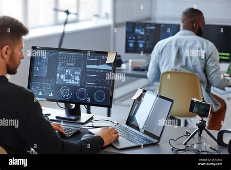 Portrait Of Male Programmer Or Data Specialist Using Computer In Office