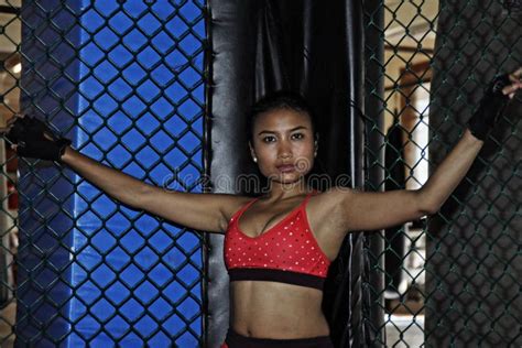 Beautiful And Asian Fighter Woman In Fighting Gloves And Sport Clothes