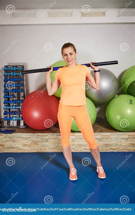 Slim Athletic Young Woman In Sportswear Does Exercises Using Expander