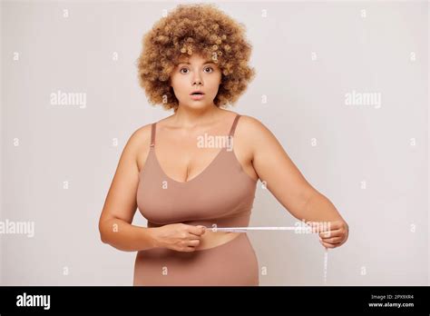 pretty chubby woman with surprised and unexpected emotion check her