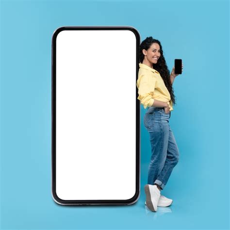 Premium Photo Happy Young Woman Standing Near Big Cellphone With Empty White Screen Showing