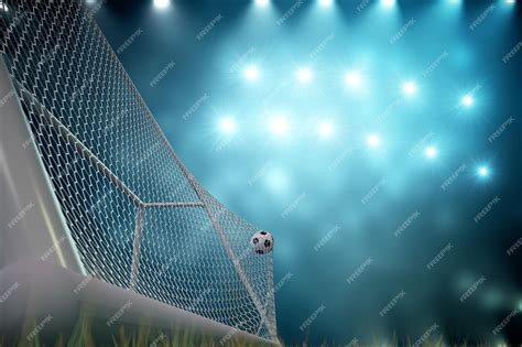 목표에 3d 렌더링 축구공입니다 스포트라이트와 경기장 조명 배경 성공 개념이 있는 그물에 축구공 잔디와 파란색 배경에