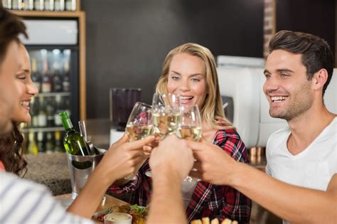 Premium Photo Friends Toasting With Glasses Of White Wine