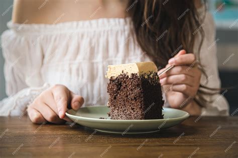 Free Photo A Woman Eats A Piece Of Chocolate Cake Closeup