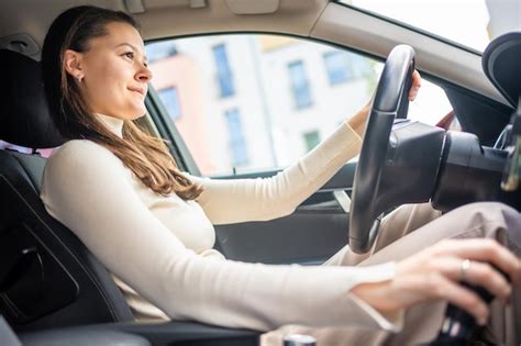Premium Photo Happy Woman Driving A Car And Smiling Cute Young