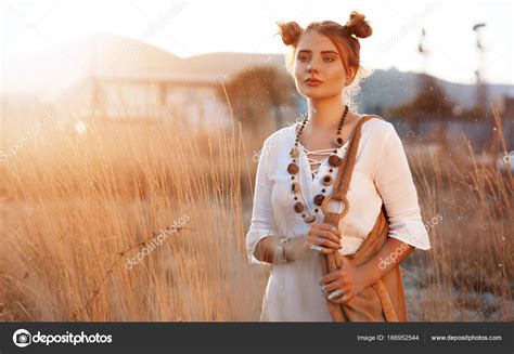 Hippie Girl In Ornaments Boho Chic Stands In A Field At Sunset Stock