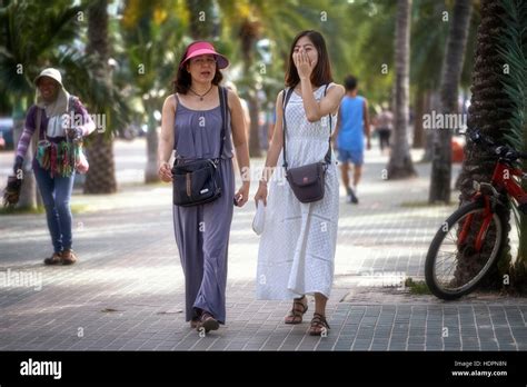 Surprised Look From Two Women Spotting The Photographer Caught In The