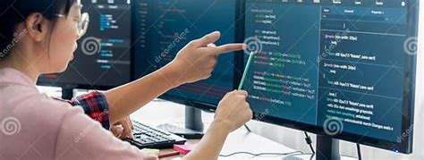female programer explain while pointing code displayed on computer