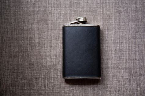 Premium Photo A Black Flask With A Silver Flask On A Gray Background