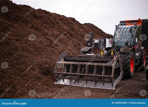 Industrial Composting Facility With Heavy Machinery And Compost Piles