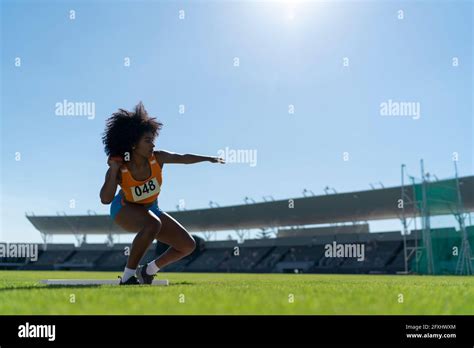 Female Track And Field Athlete Throwing Shot Put In Sunny Stadium Stock Photo Alamy