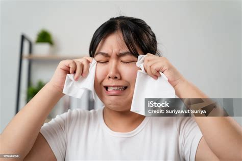 Portrait Of A Sad Asian Woman Crying Wipes Her Tears With A Tissue