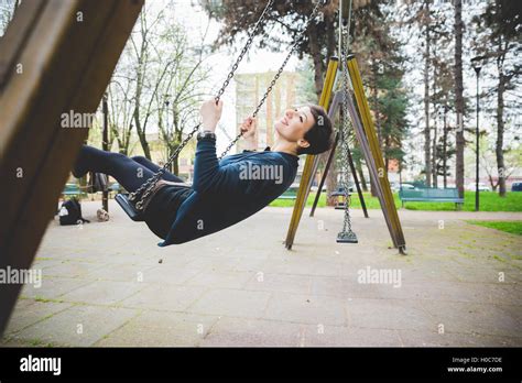 Young Handsome Caucasian Short Brown Hair Woman Having Fun On A Seesaw
