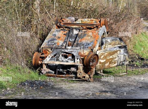 Wrecked Car Turned Upside Down On The Side Of The Road After Being