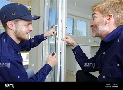 Workemn Either Side Of A Door Testing Lock Stock Photo Alamy
