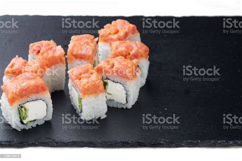 전통적인 맛있는 신선한 초밥은 반사와 검은 색 배경에 롤 쌀 크림 치즈 붉은 생선 연어와 함께 초밥 롤 초밥 메뉴 일식 레스토랑