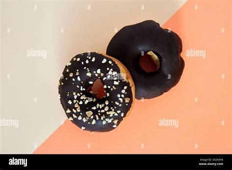 Two Chocolate Covered Donuts With Crush Nuts On Top Zenithal Angle On