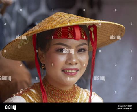 Toraja Woman In Traditional Colourful Clothes With Rice Straw Hat