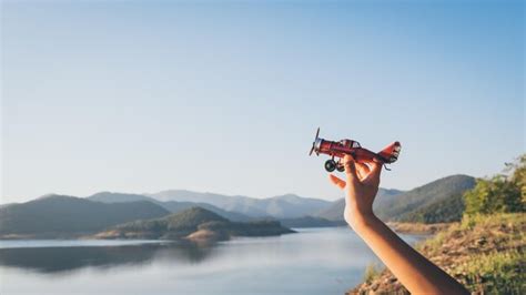 Premium Photo Cropped Hand Holding Toy Airplane