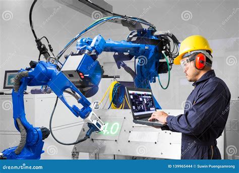 Engineer Using Laptop Computer Control Laser Robotic Cutting On Metal