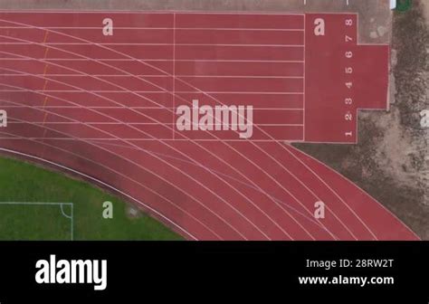 Aerial View Of A Local Track Field Showcasing Multiple Running Lanes