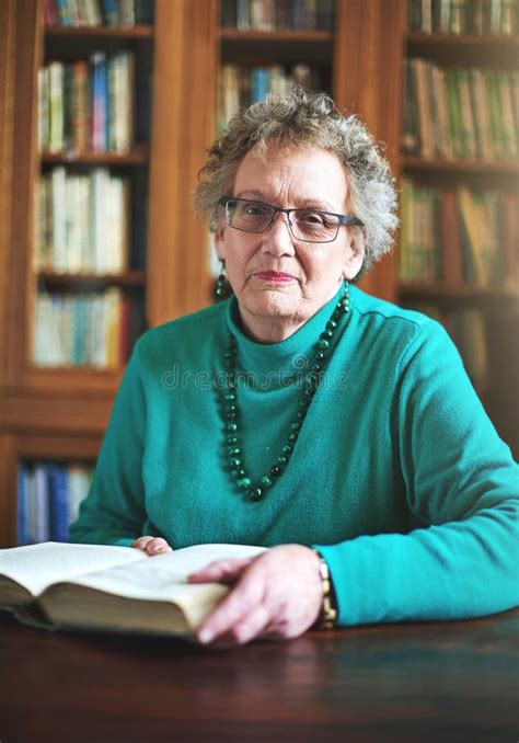 Getting In A Great Read Portrait Of A Senior Woman Sitting At A Table