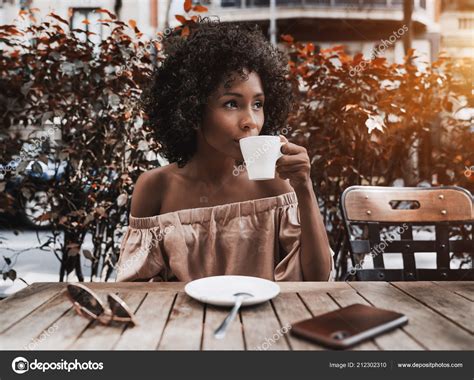 Beautiful African American Female Drinking Delicious Tea Looking Aside
