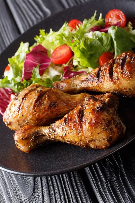 Crispy Grilled Chicken Legs And Fresh Vegetable Salad Close Up Stock