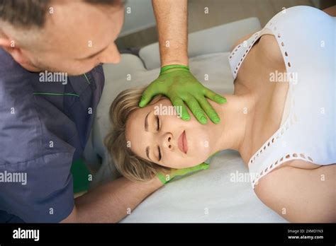 Osteopathic Physician Conducting Cervical Spine Mobilization On Woman