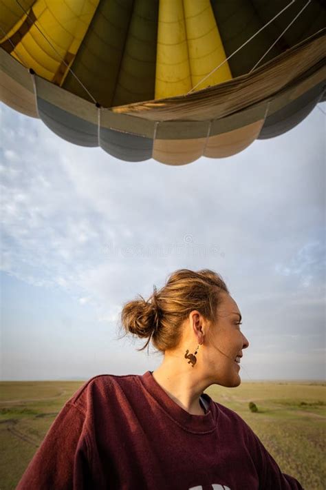 Woman Looks Out To The Masai Mara Reserve While In The Air In A Hot Air