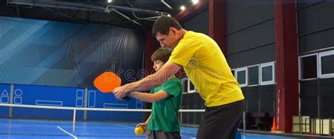 A Boy And A Girl Playing Pickleball On A Blue Ins Stock Footage