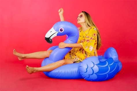 Premium Photo Blonde Hair Woman Sitting On Flamingo Float