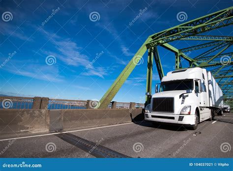 Big Rig White Semi Truck With Dry Van Trailer Transporting Commercial