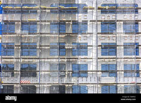 Building Facade Under Construction With Scaffolding And Protective Net Stock Photo Alamy