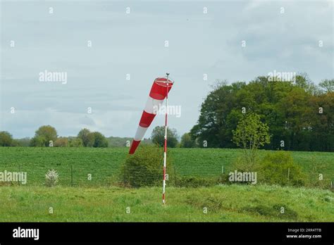 A Red And White Wind Cone Indicating The Direction And Strength Of The