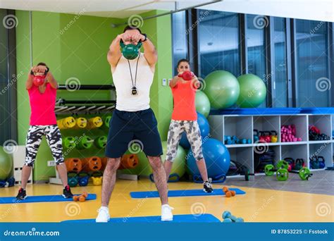 Kettlebells Swing Exercise Man And Woman Workout At Gym Stock Image