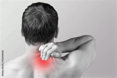 Foto Stock Man Suffering From Shoulder Blade Pain Trigger Point Hand Holding Shoulder With Red