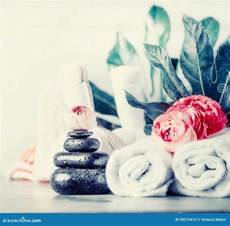 Spa Setting With Hot Black Basalt Massage Stones Flowers Towels And
