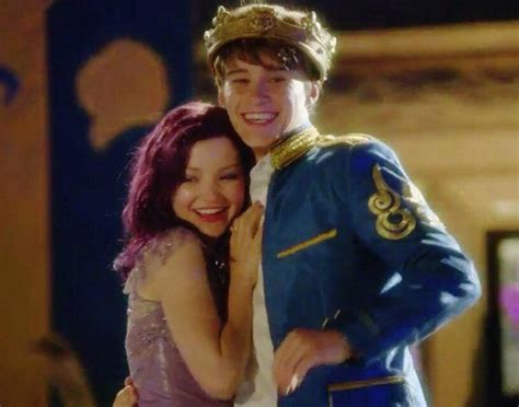 A Man And Woman Dressed As Disney Characters Hugging Each Other In