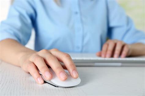 Premium Photo Female Hand With Computer Mouse On Table Closeup