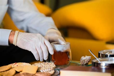 Premium Photo Midsection Of Man Holding Wine Glass On Table