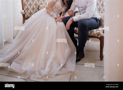The Groom And The Bride Are Sitting On Bed Stock Photo Alamy