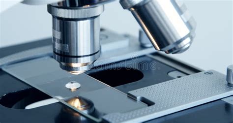 Close Up Of Examining Of Test Sample Of Microchip Transistor Under The Microscope In Laboratory