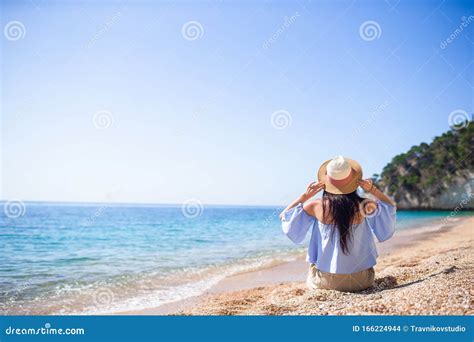 Woman Laying On The Beach Enjoying Summer Holidays Looking At The Sea