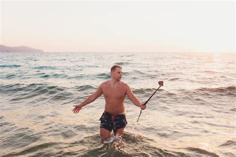Man Swimming Trunks Being In The Water Sea Selfie Stick Action