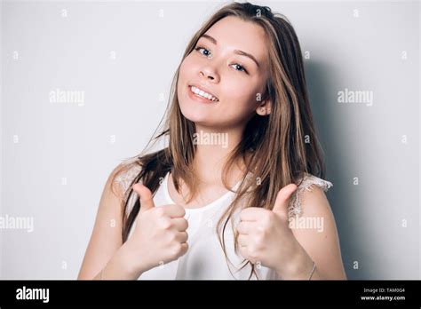 Enthusiastic Motivated Attractive Young Woman Giving A Thumbs Up